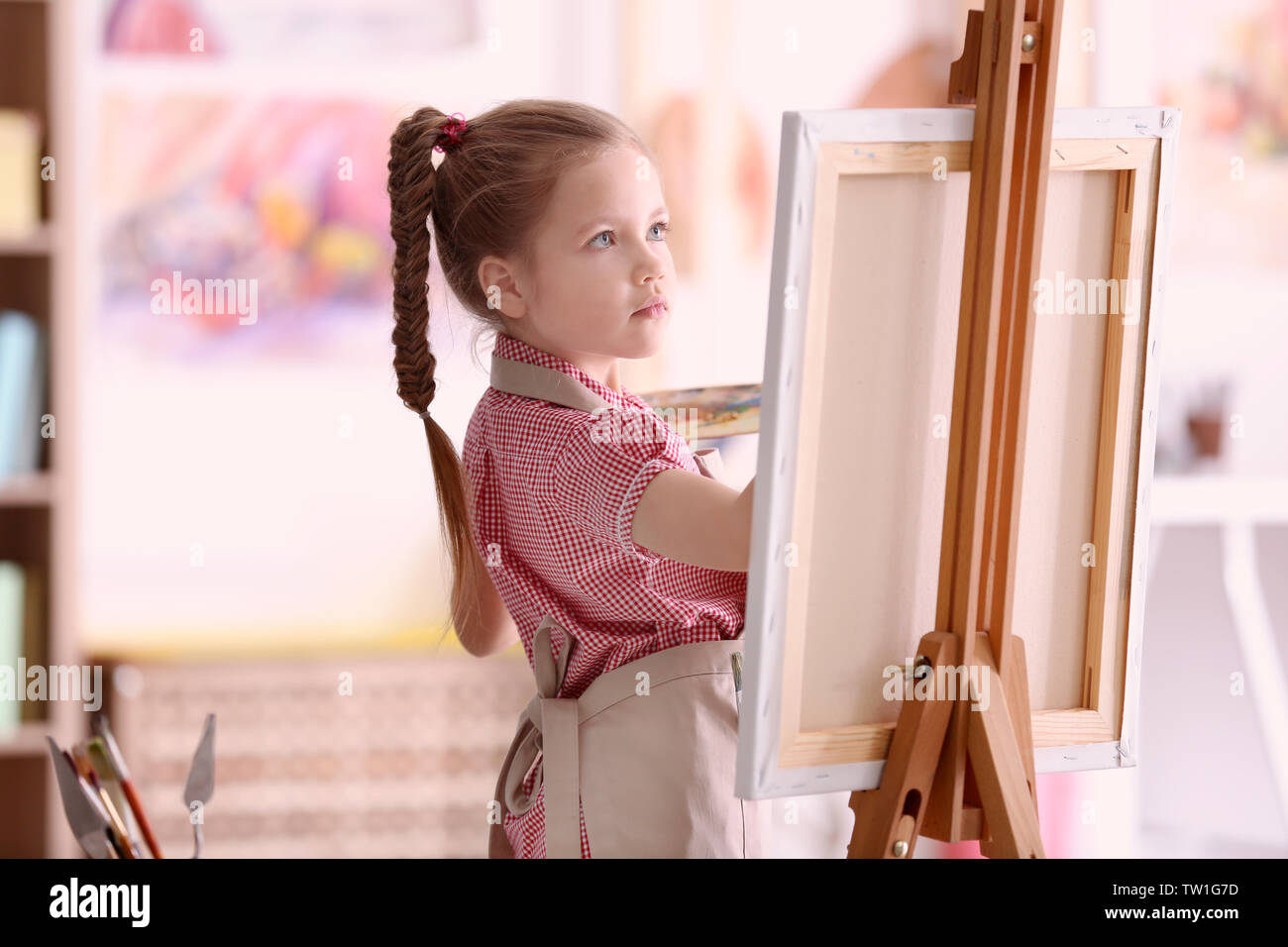 Cute little artist painting picture in studio Stock Photo - Alamy