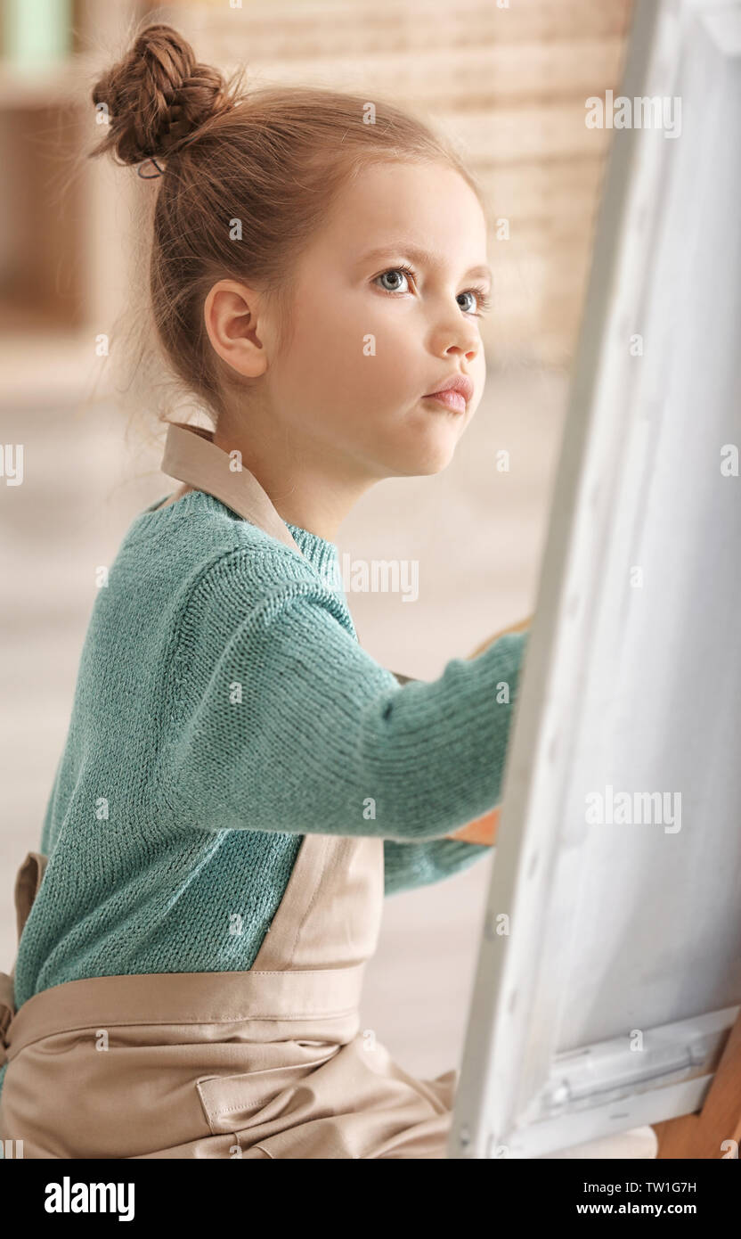 Cute little artist painting picture in studio Stock Photo - Alamy