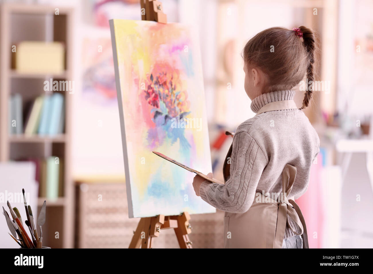Cute little artist painting picture in studio Stock Photo - Alamy