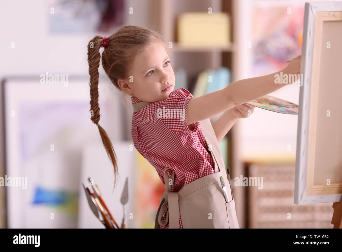 Cute little artist painting picture in studio Stock Photo - Alamy