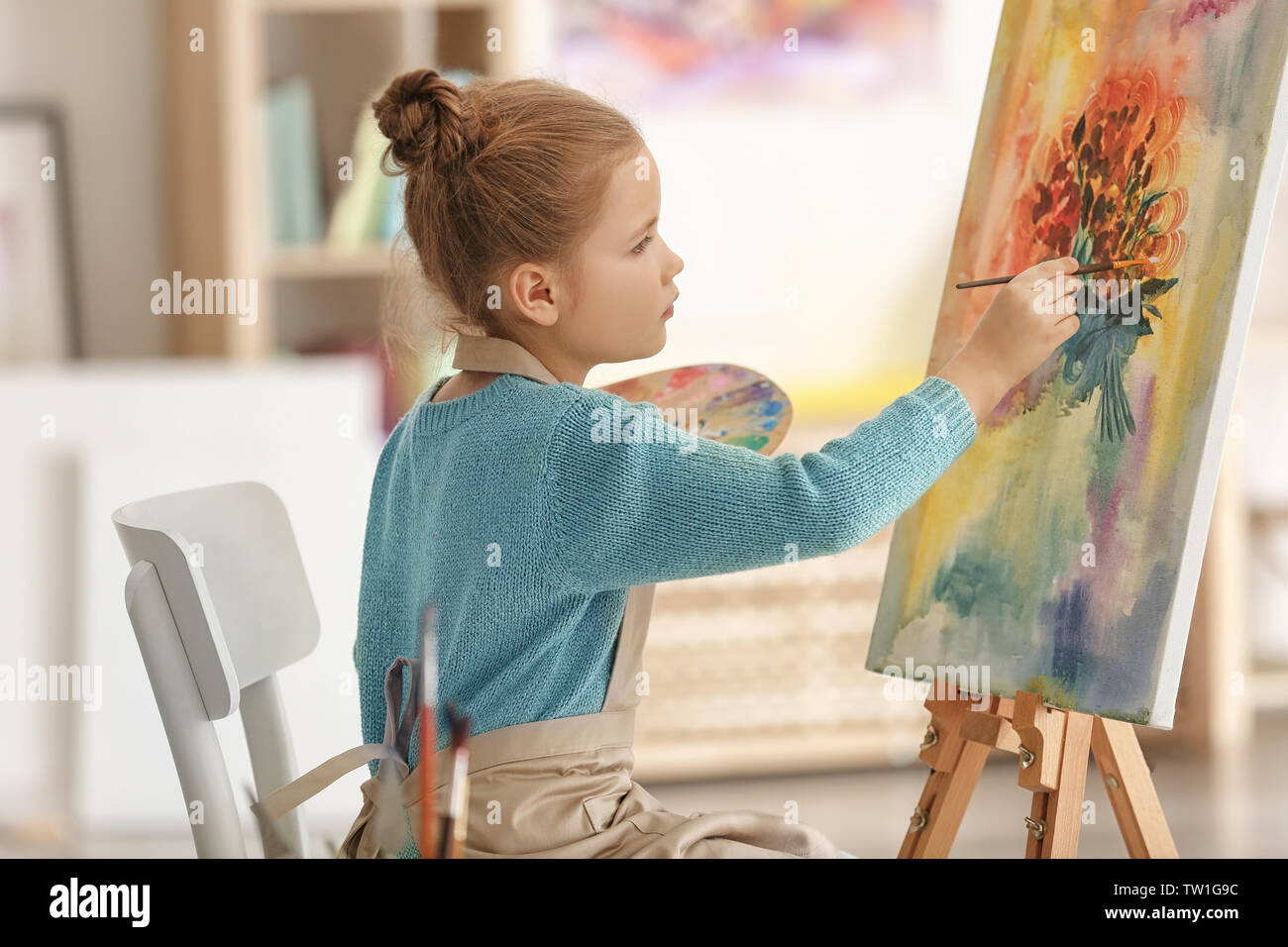 Cute little artist painting picture in studio Stock Photo - Alamy