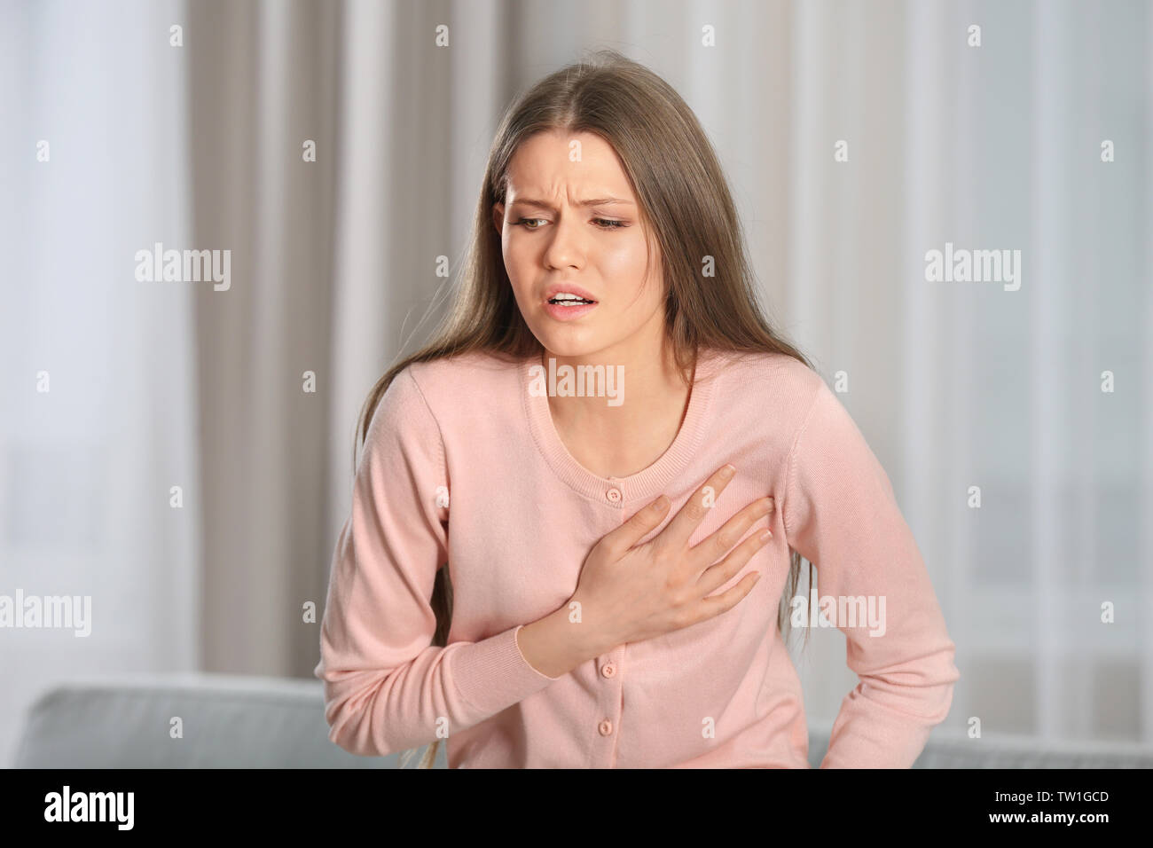 Girl having a heart attack at home Stock Photo - Alamy