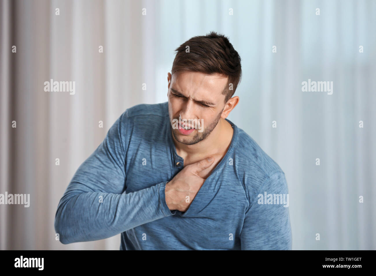 Man having a heart attack at home Stock Photo - Alamy