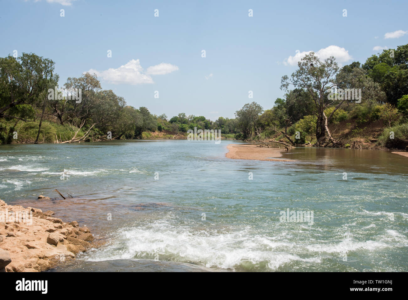 Daly River scene with native bushland, sandy shore and blue skies in ...