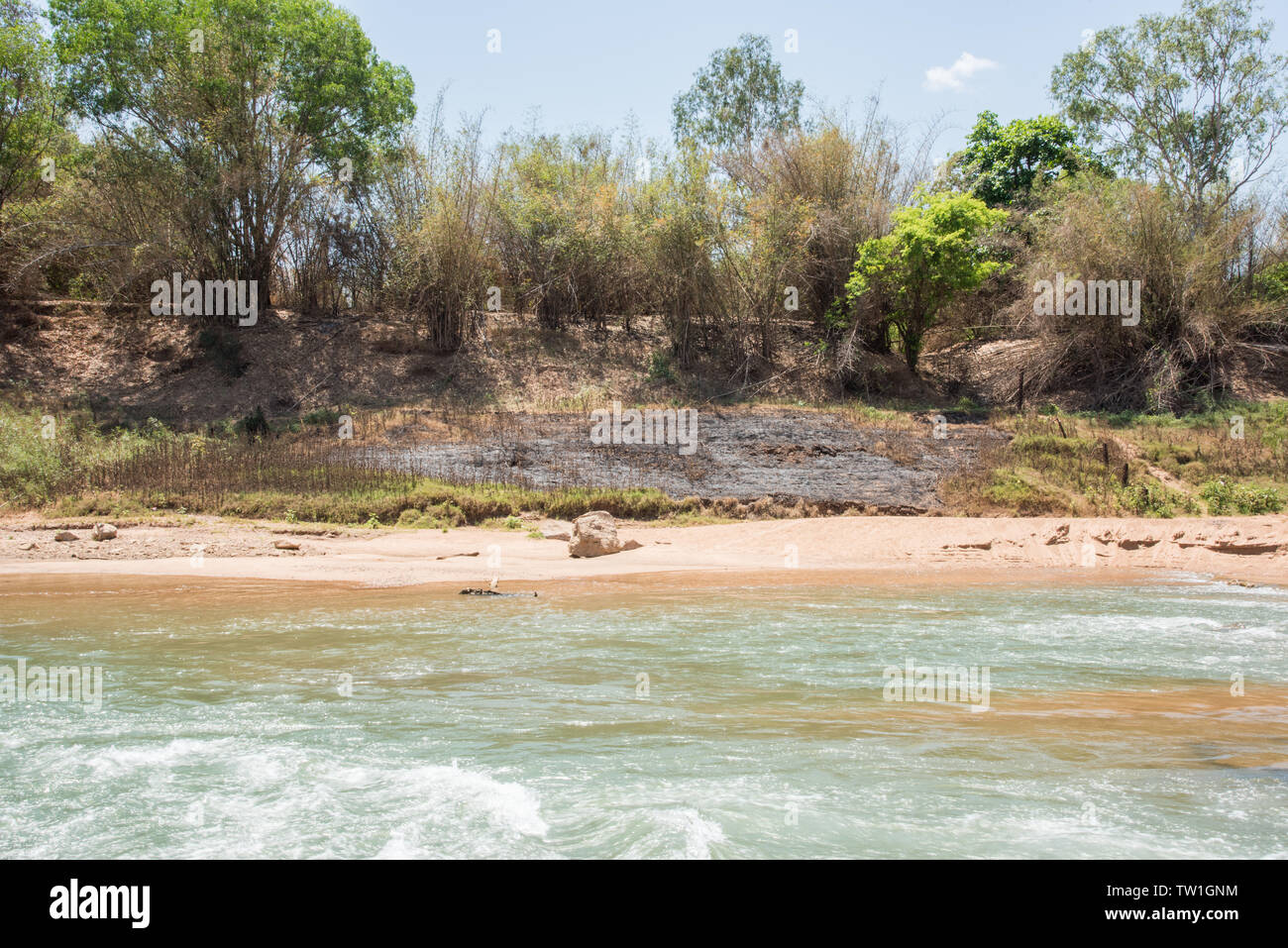 Daly River scene with native bushland, sandy shore and blue skies in ...