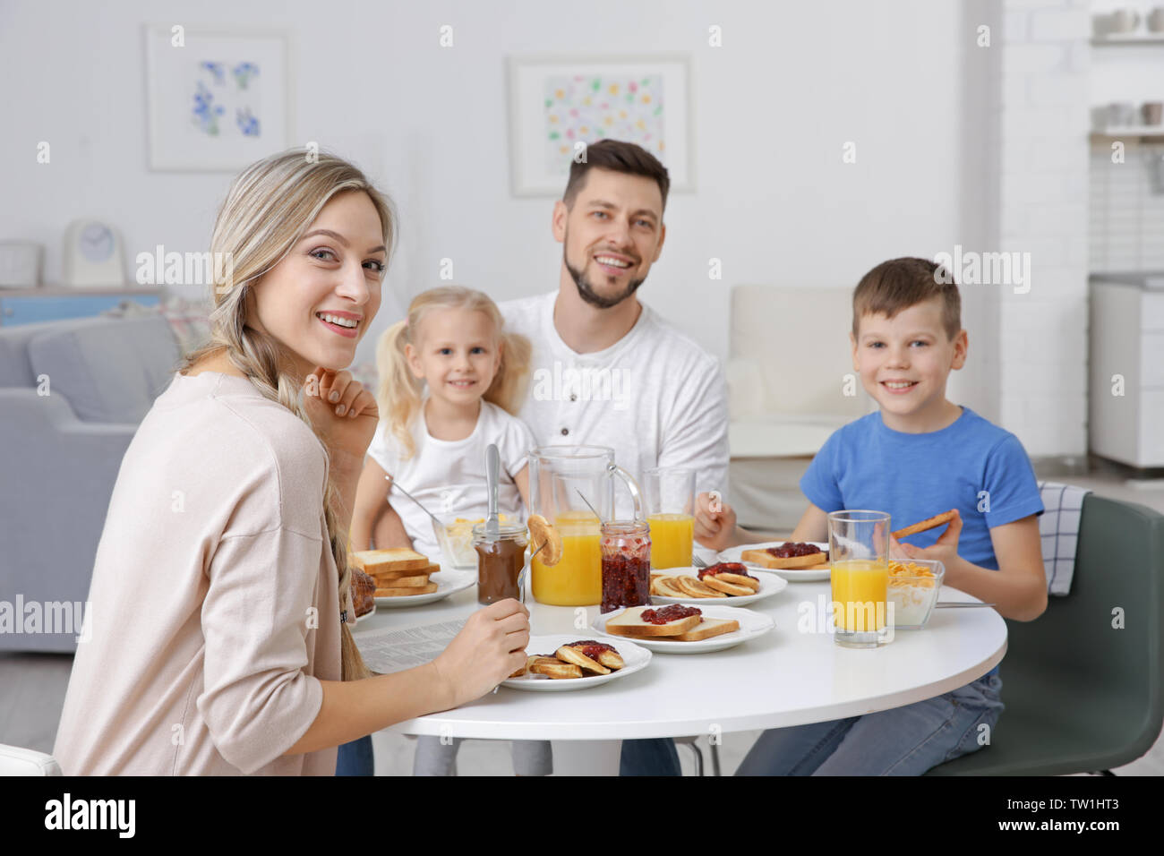 Happy family having breakfast on kitchen Stock Photo - Alamy