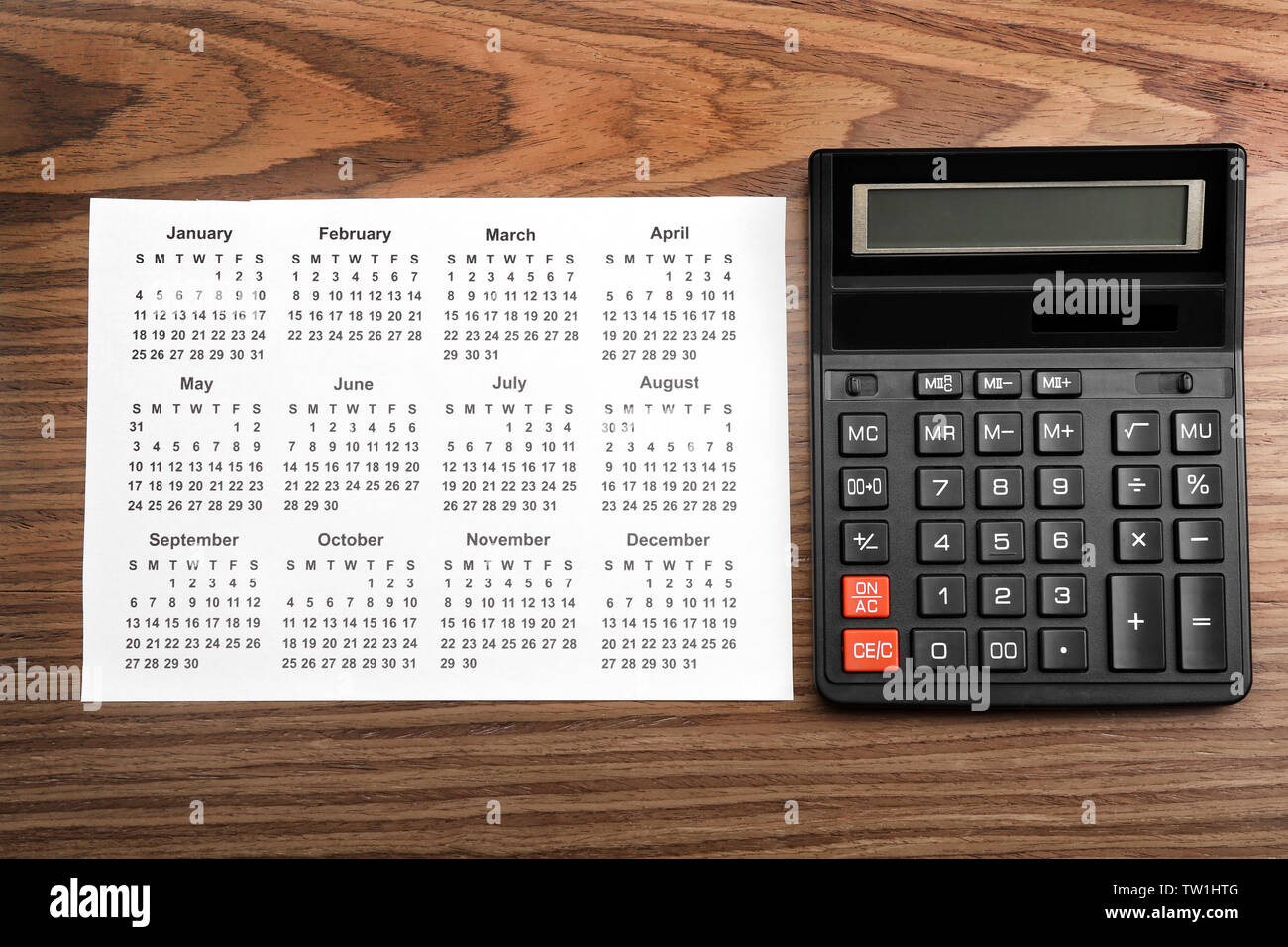 Calculator with calendar on table. Tax concept Stock Photo - Alamy