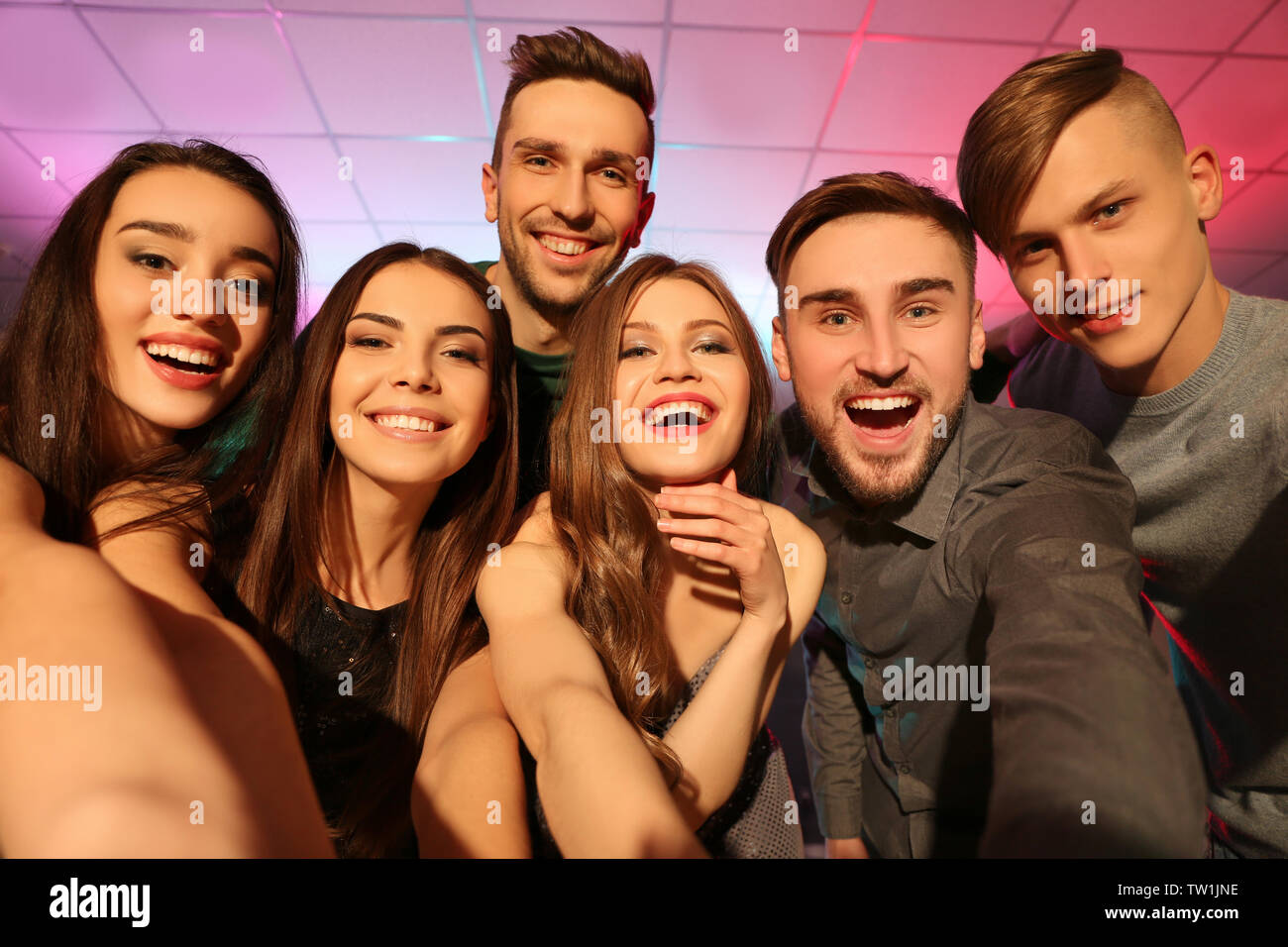 Friends having fun at party in night club Stock Photo - Alamy