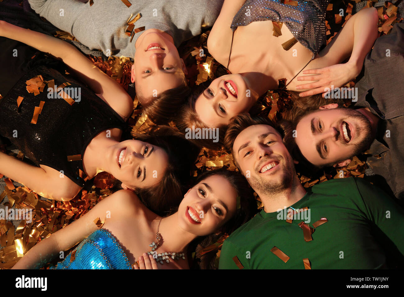 Friends lying on floor at party in night club Stock Photo - Alamy
