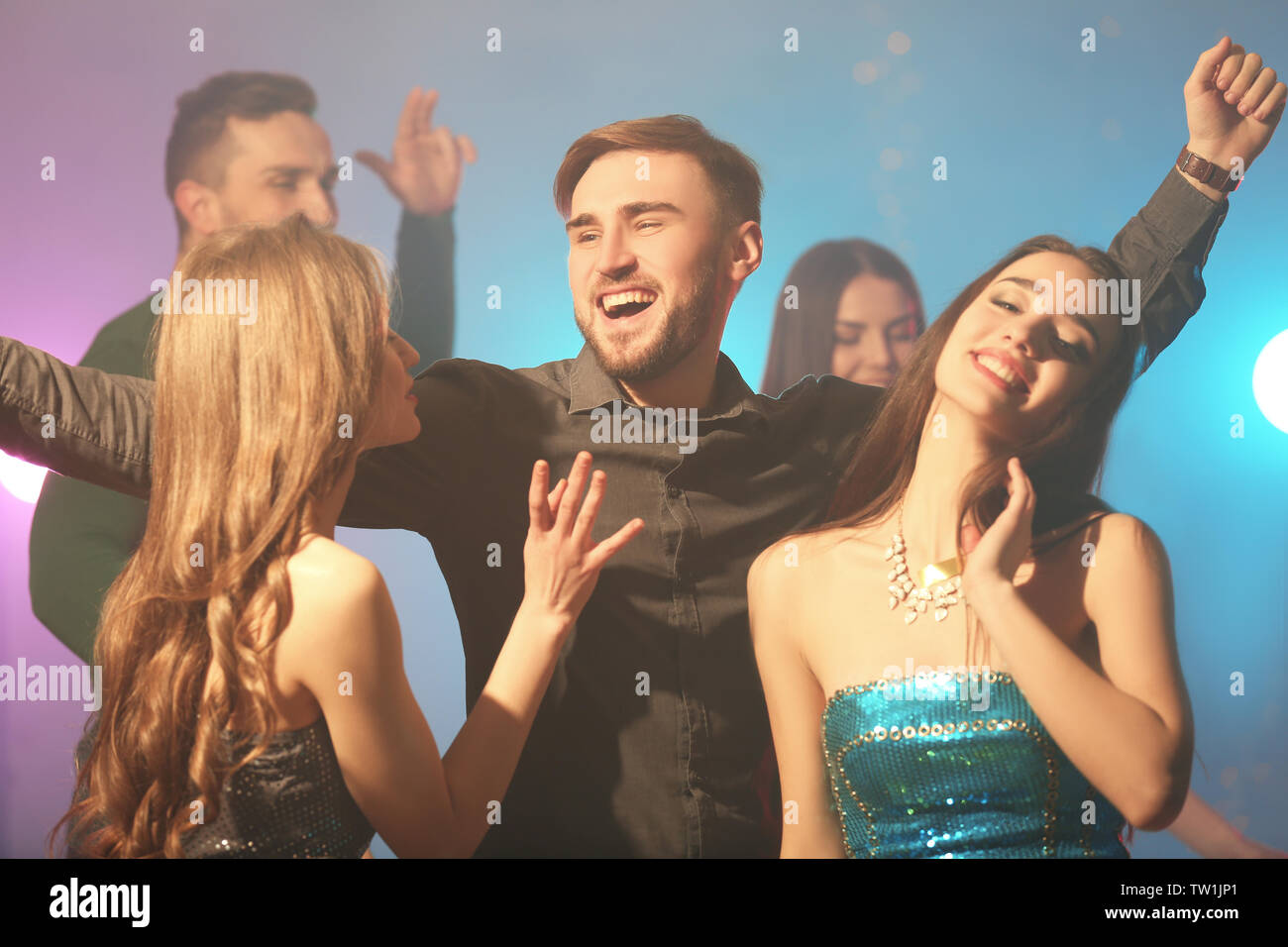 Friends having fun at party in night club Stock Photo - Alamy