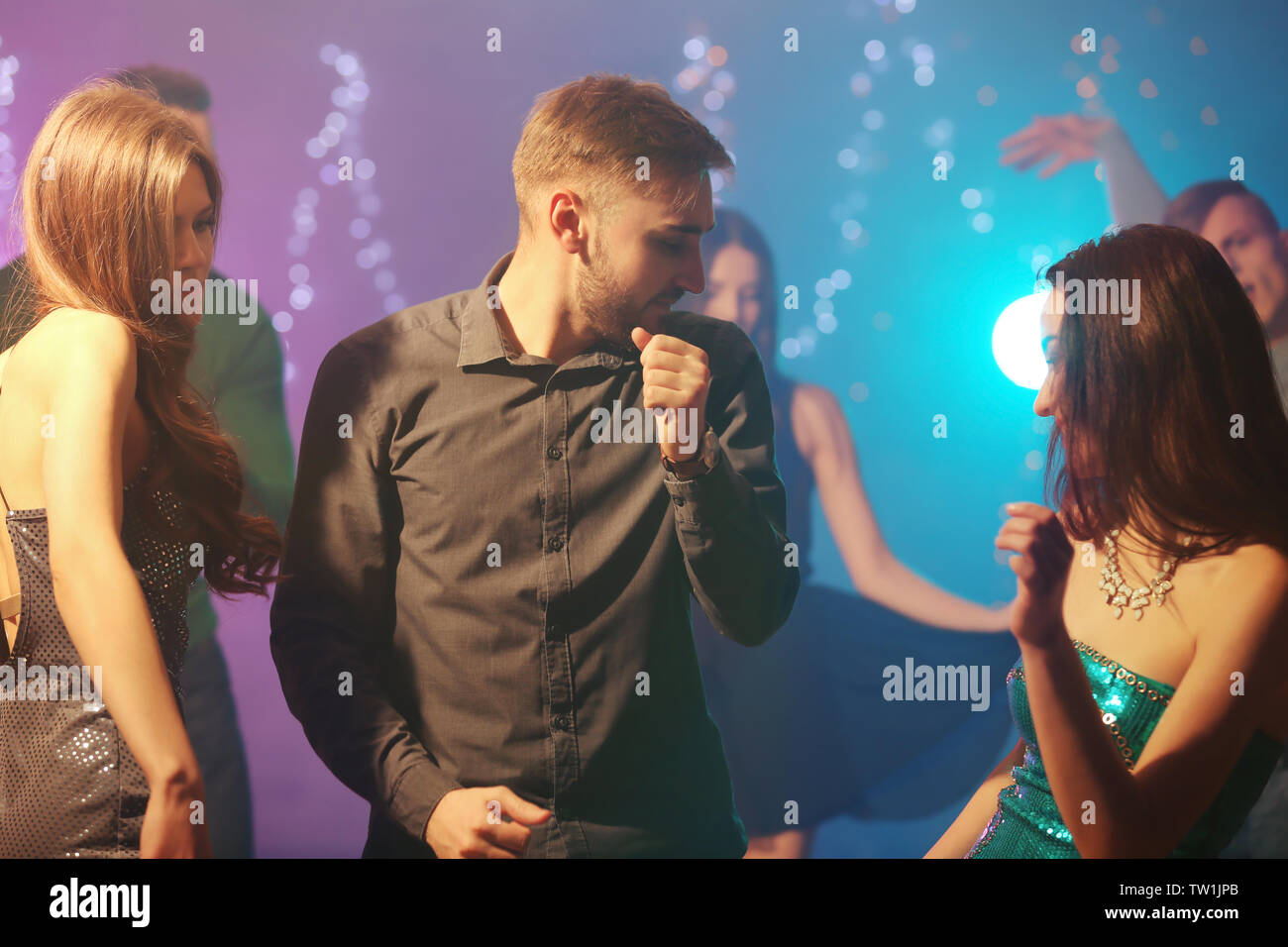 Friends having fun at party in night club Stock Photo - Alamy