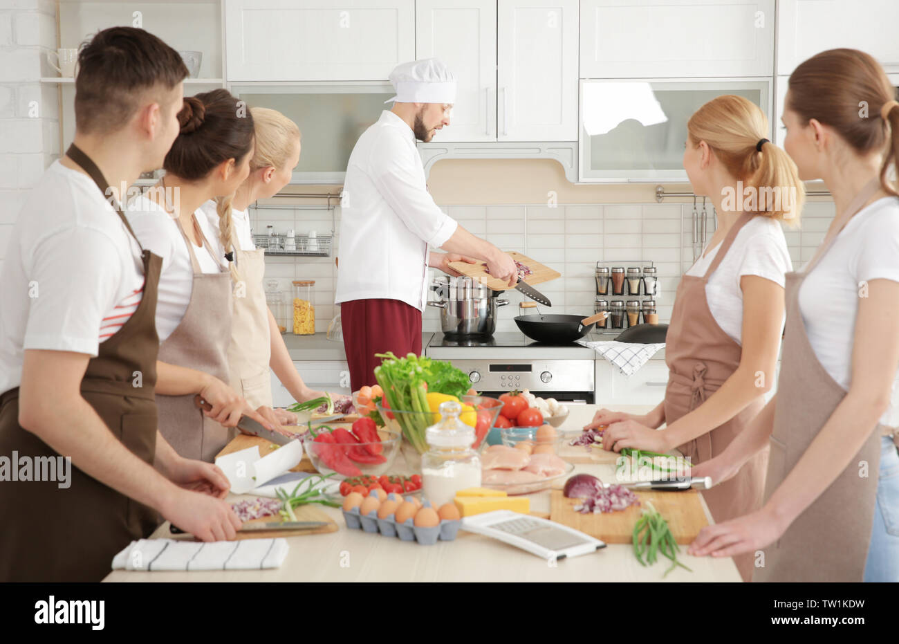 Male chef and group of people at cooking classes Stock Photo - Alamy