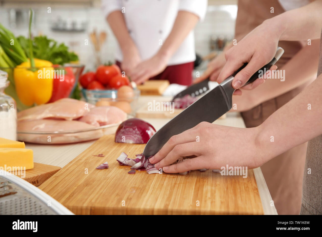 People cutting onion at cooking classes Stock Photo - Alamy