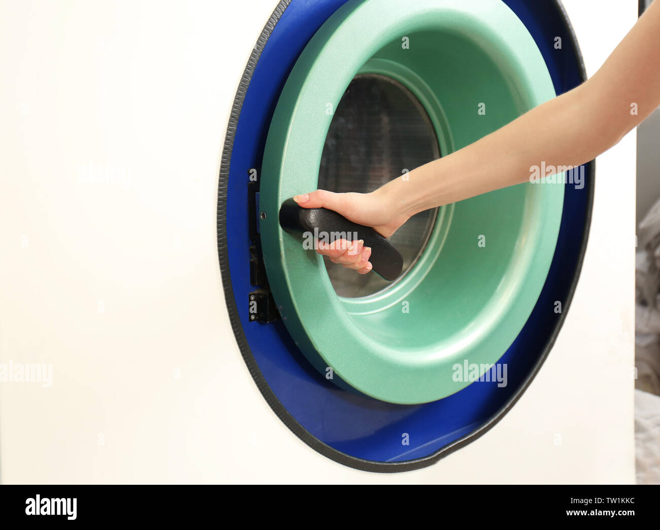 Female hand opening washing machine Stock Photo - Alamy