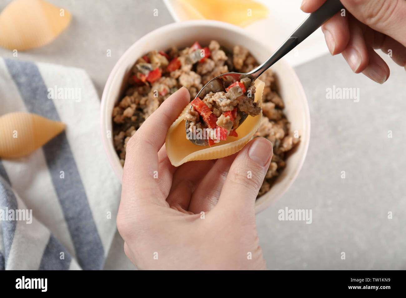 Female hands stuffing pasta, closeup Stock Photo - Alamy