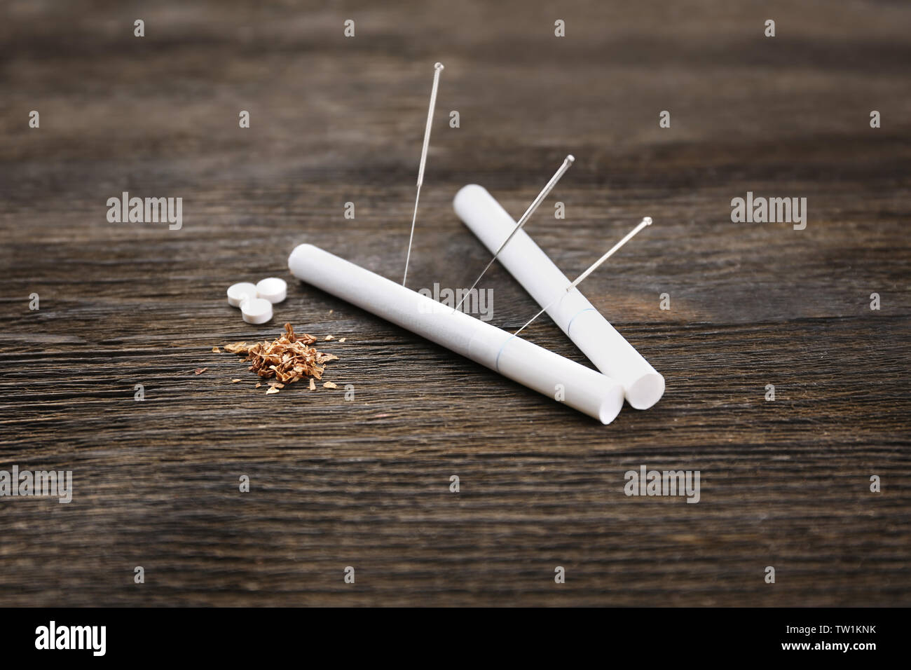 Acupuncture needles with cigarettes on wooden background Stock Photo ...