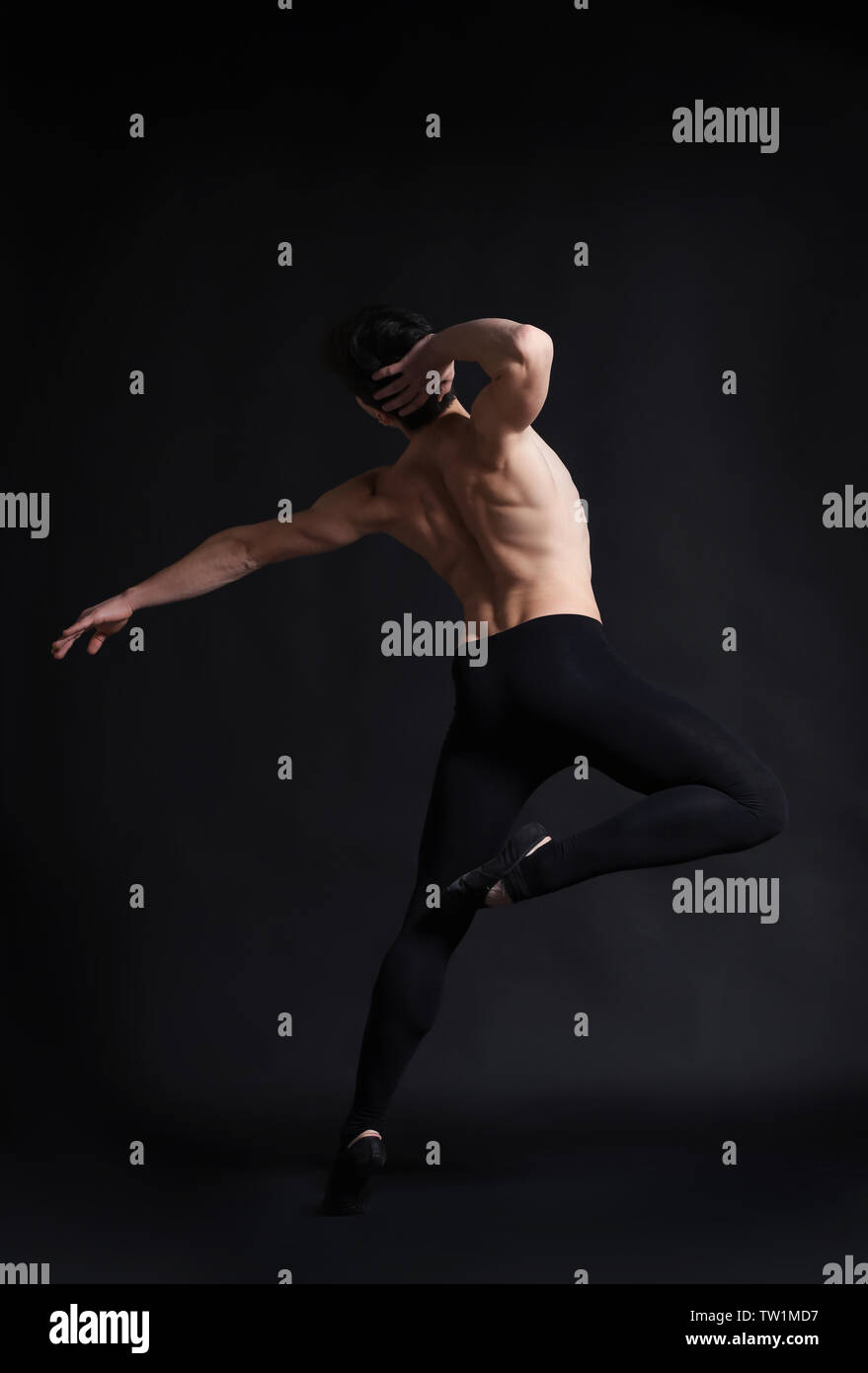 Handsome young ballet dancer on dark background Stock Photo - Alamy