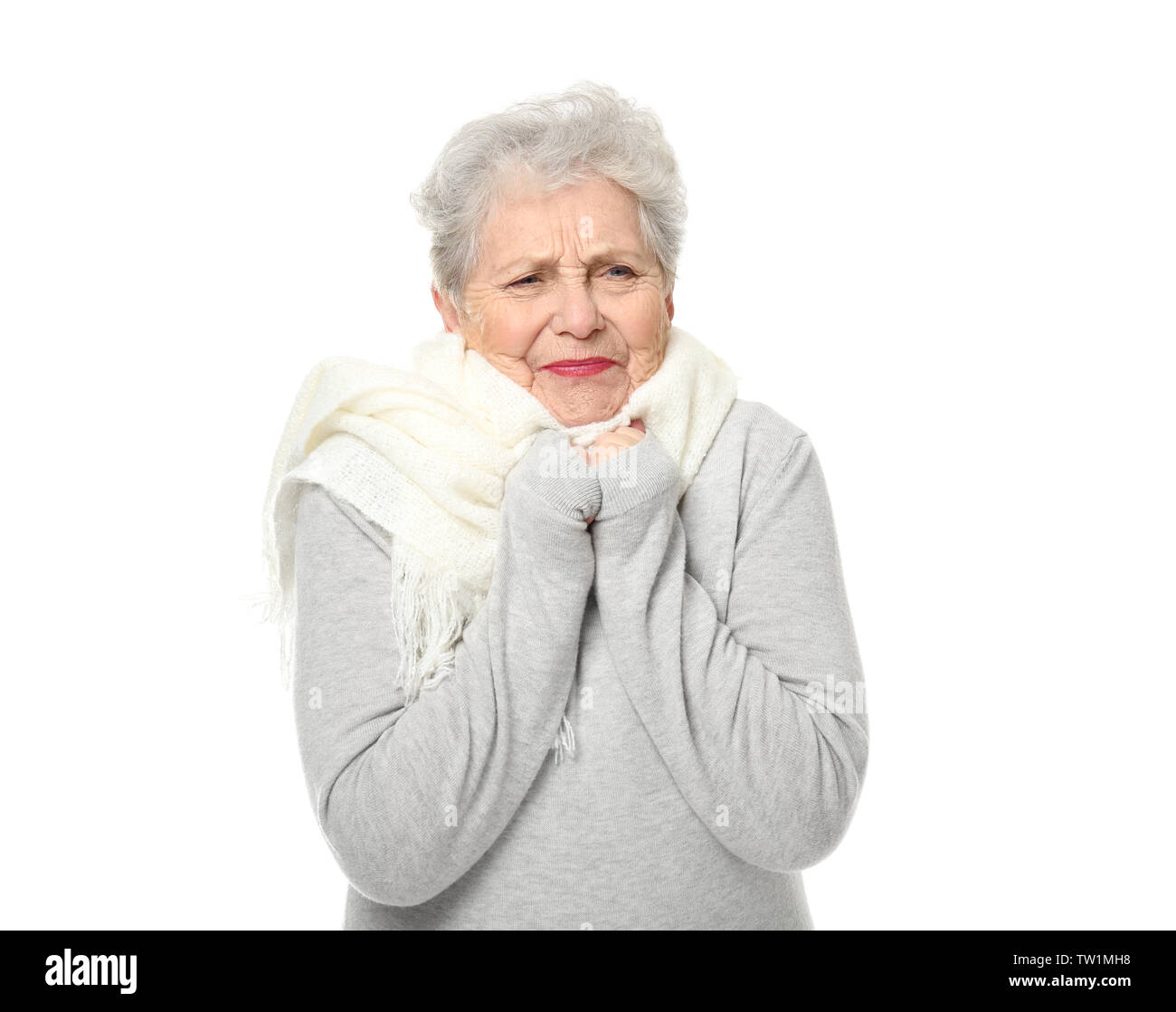 Portrait of elderly woman feeling cold on white background Stock Photo ...