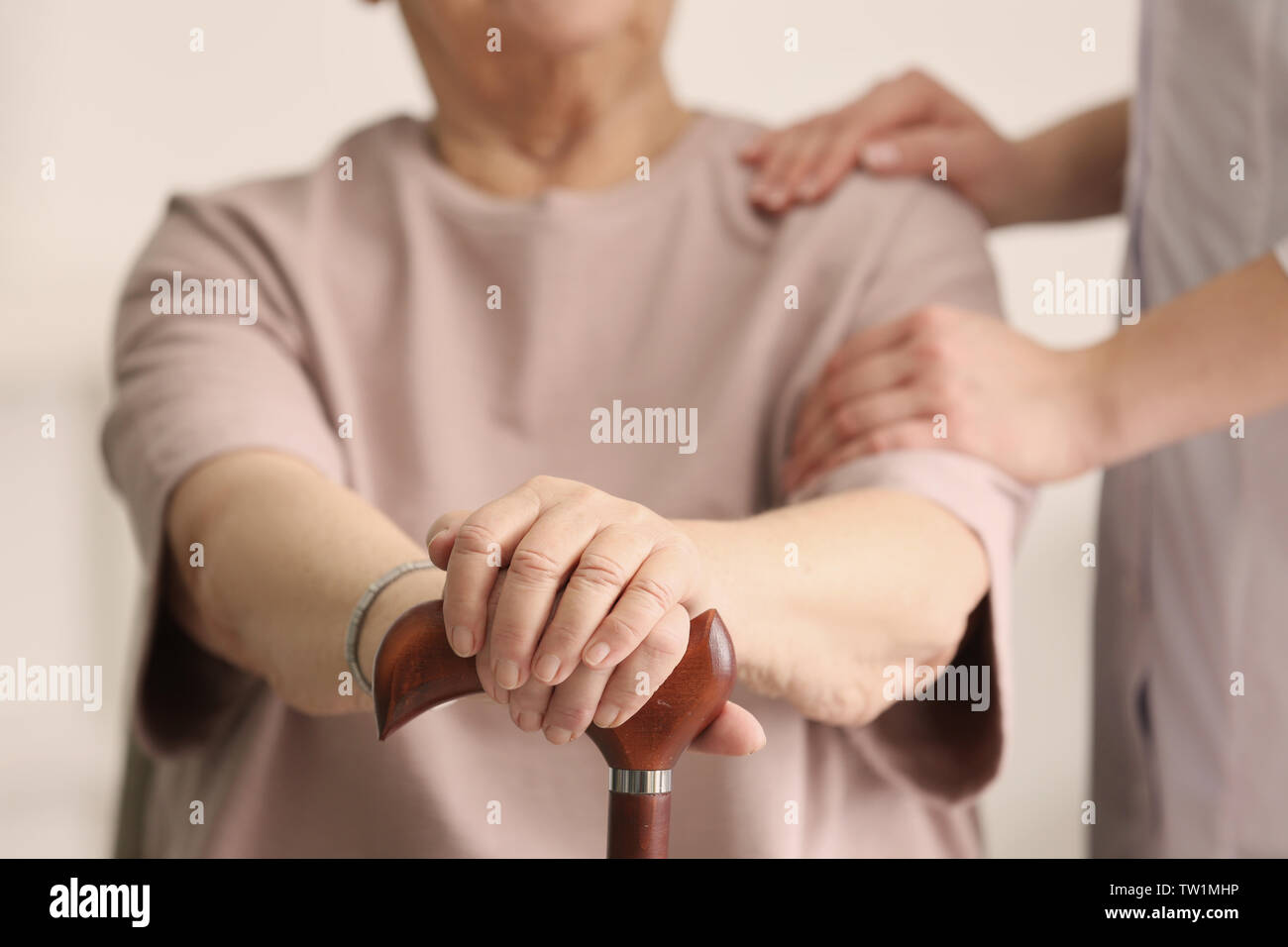 Female hands on walking stick closeup Stock Photo - Alamy