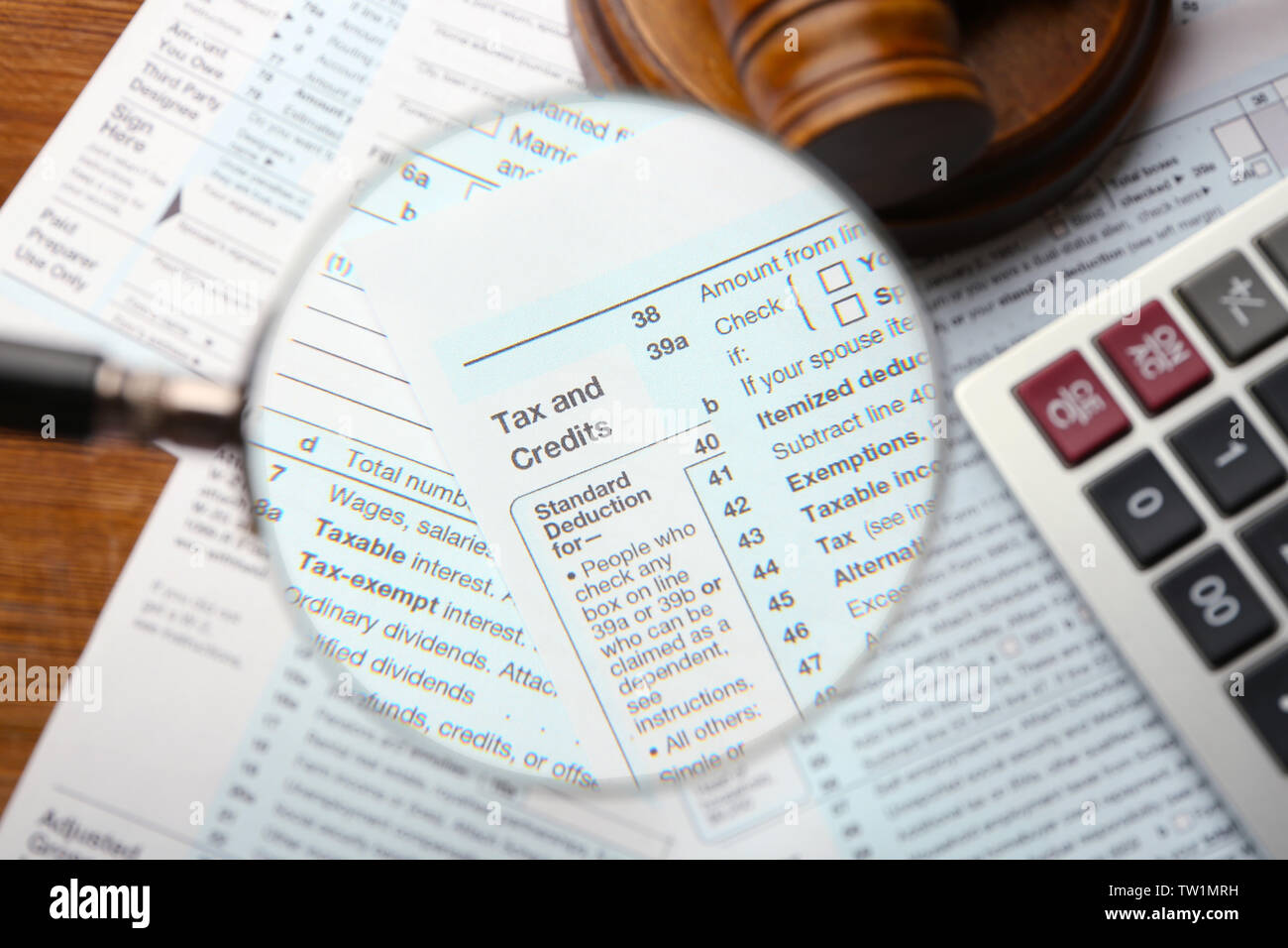 Income tax return form through magnifying glass Stock Photo - Alamy