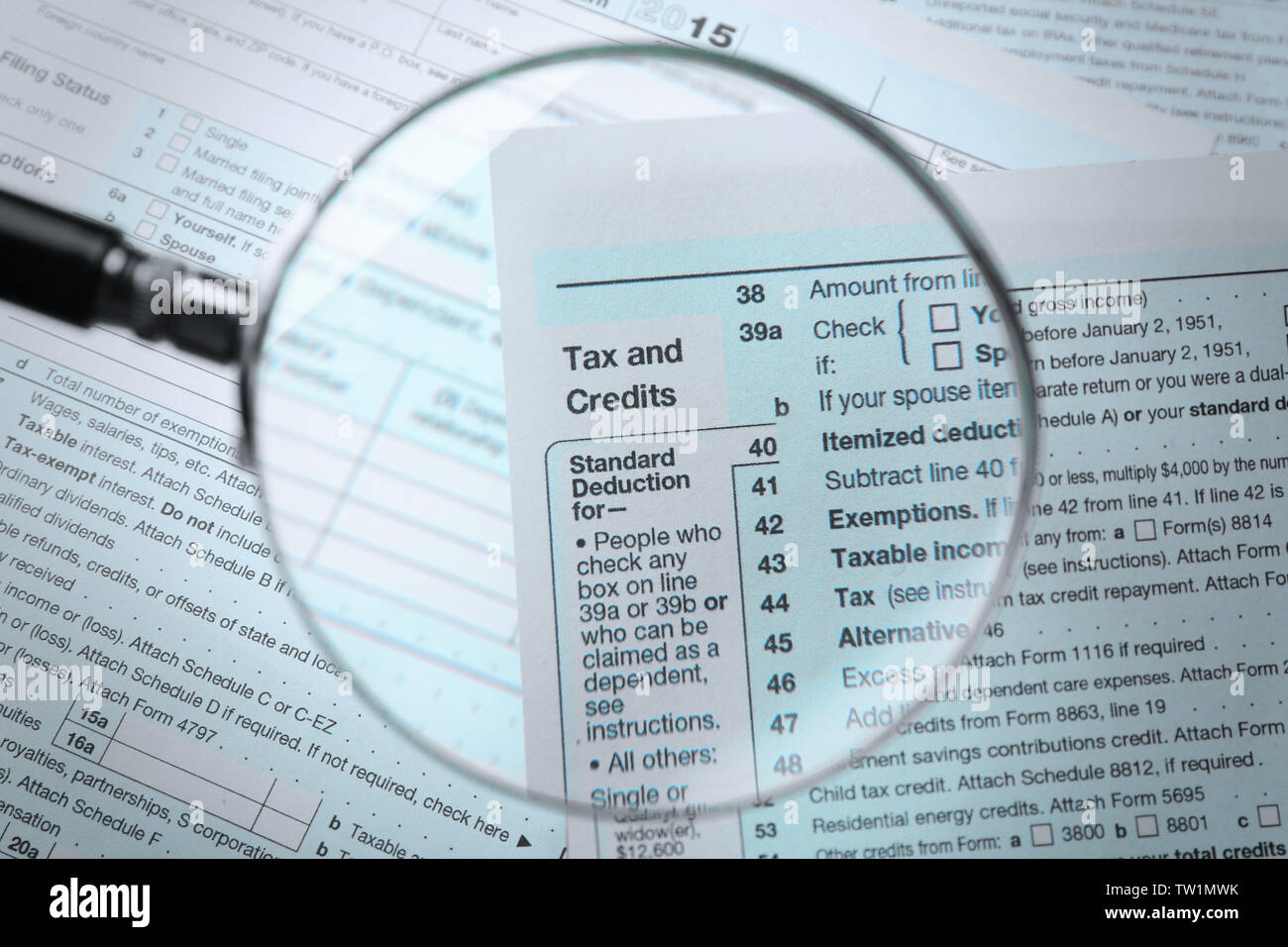 Income tax return form through magnifying glass Stock Photo - Alamy