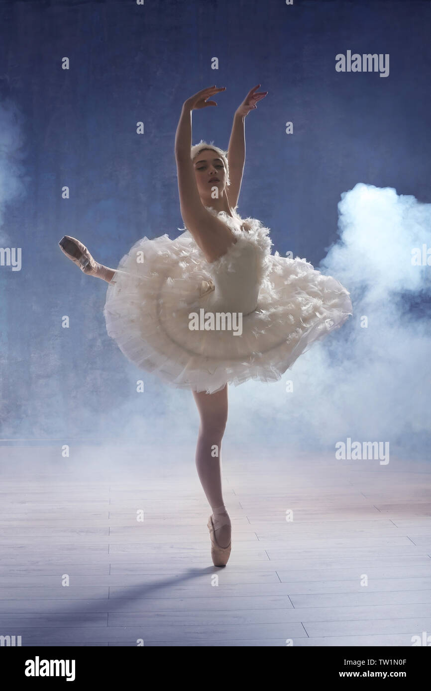 Young beautiful ballerina dancing in studio with smoke effect Stock ...