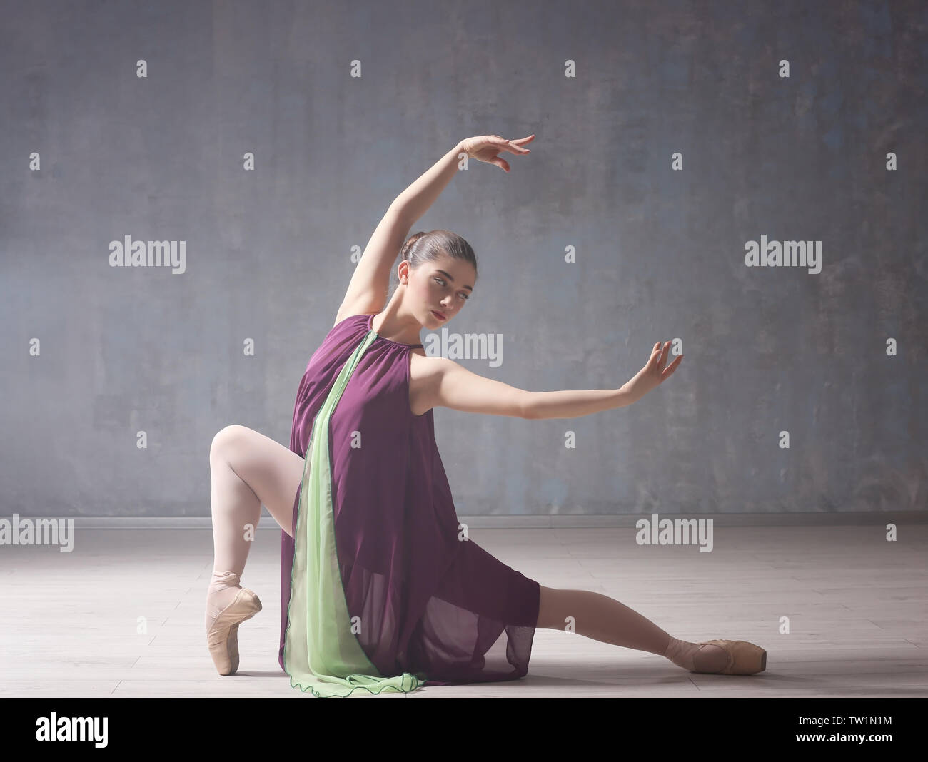 Young beautiful ballerina dancing in studio Stock Photo - Alamy