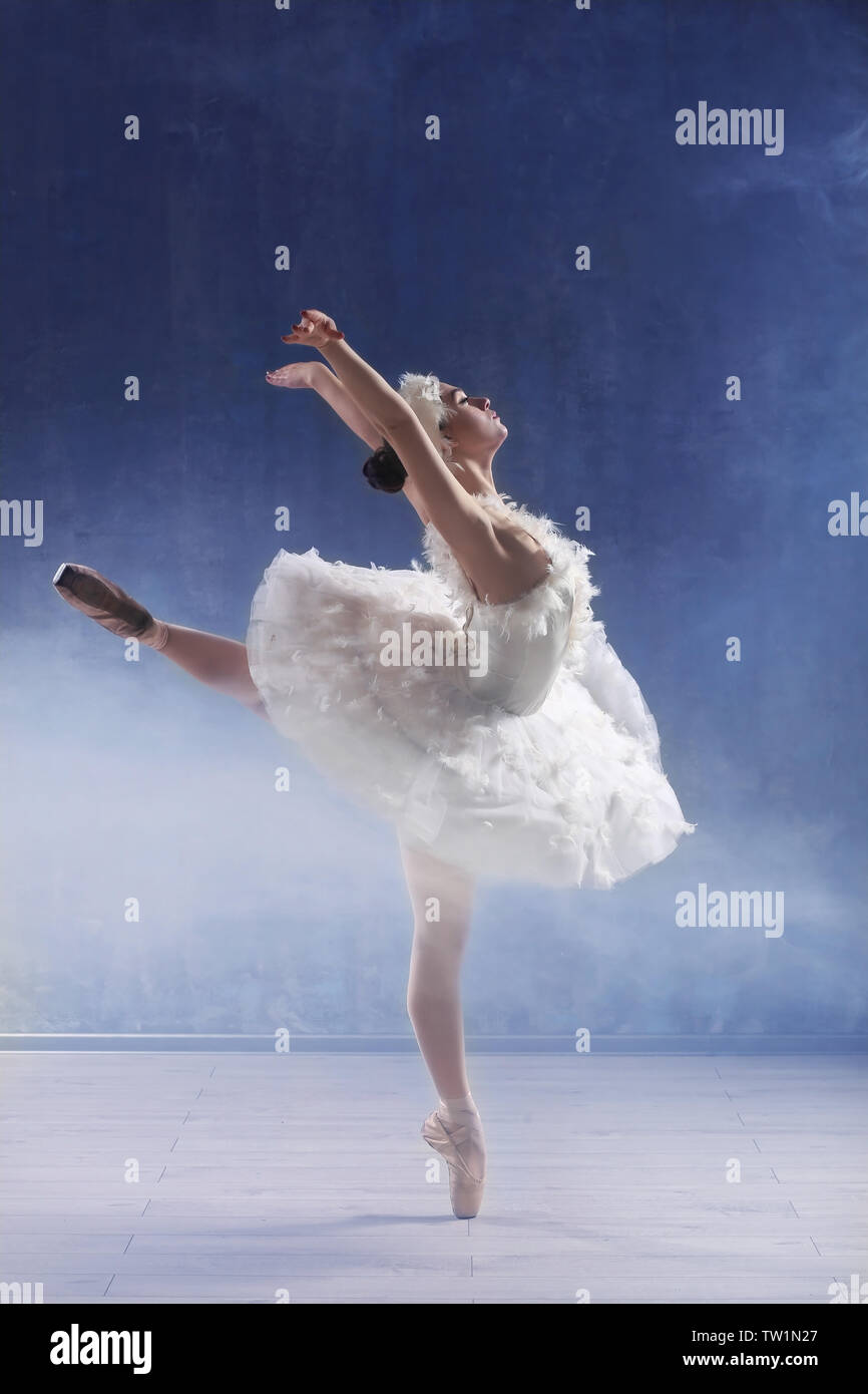 Young beautiful ballerina dancing in studio with smoke effect Stock ...