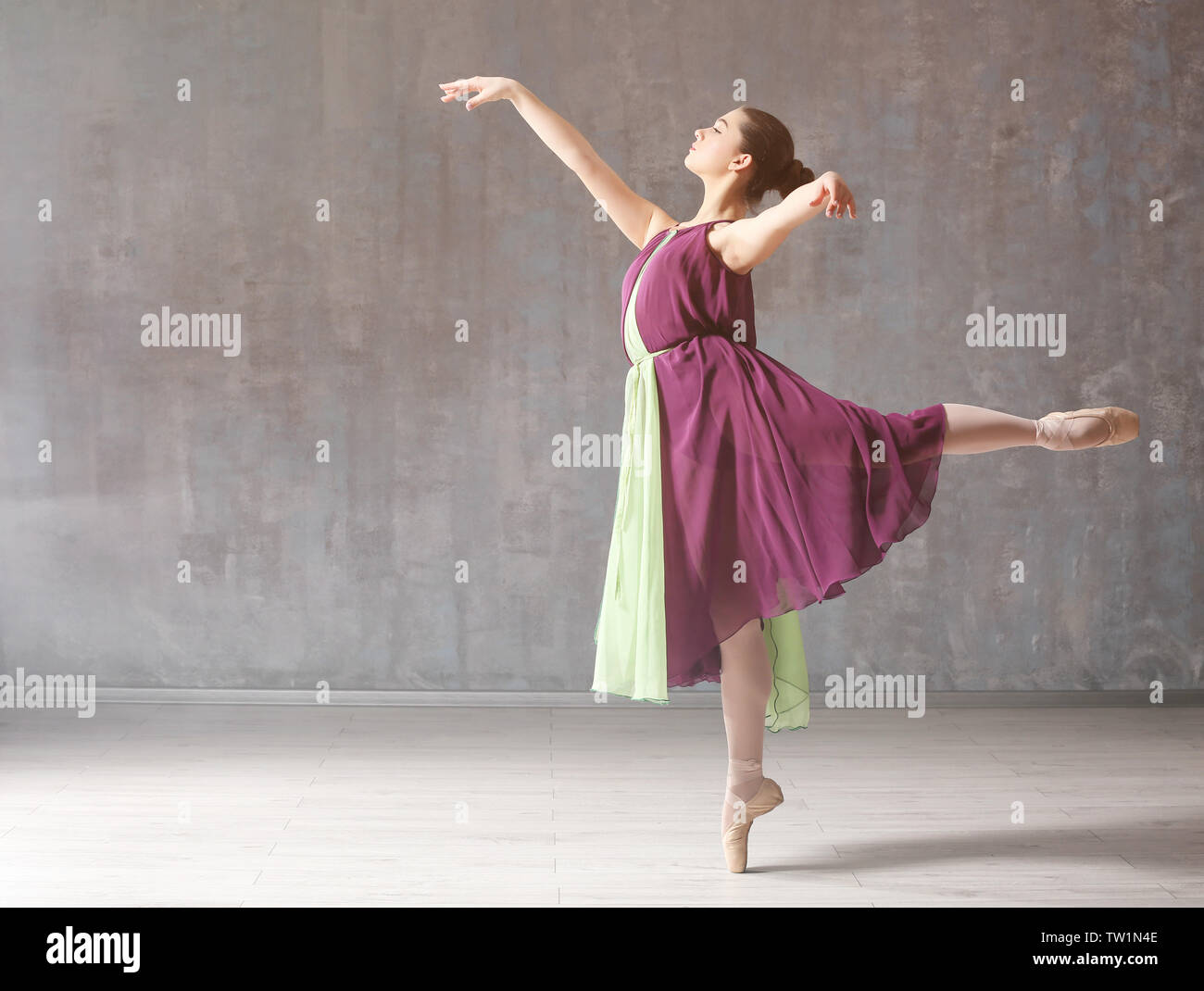 Young beautiful ballerina dancing in studio Stock Photo - Alamy