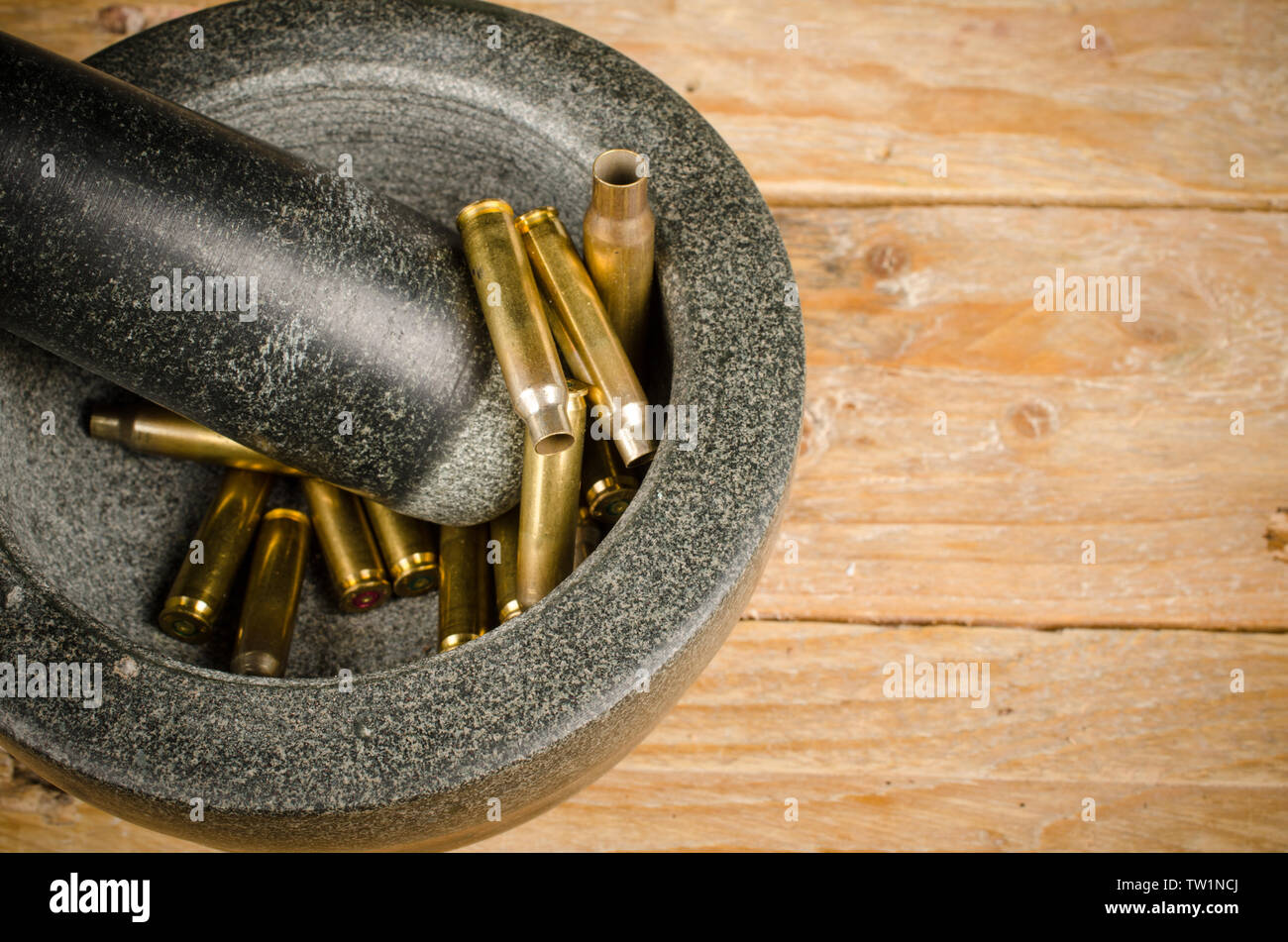 Mortar and pestle with bullets inside ready to be crushed, an anti war ...