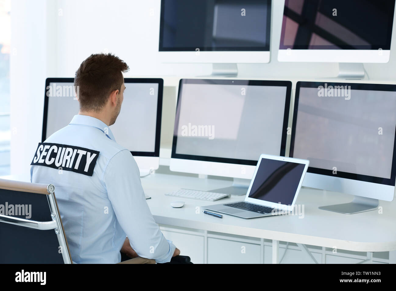Handsome security guard in surveillance room Stock Photo - Alamy