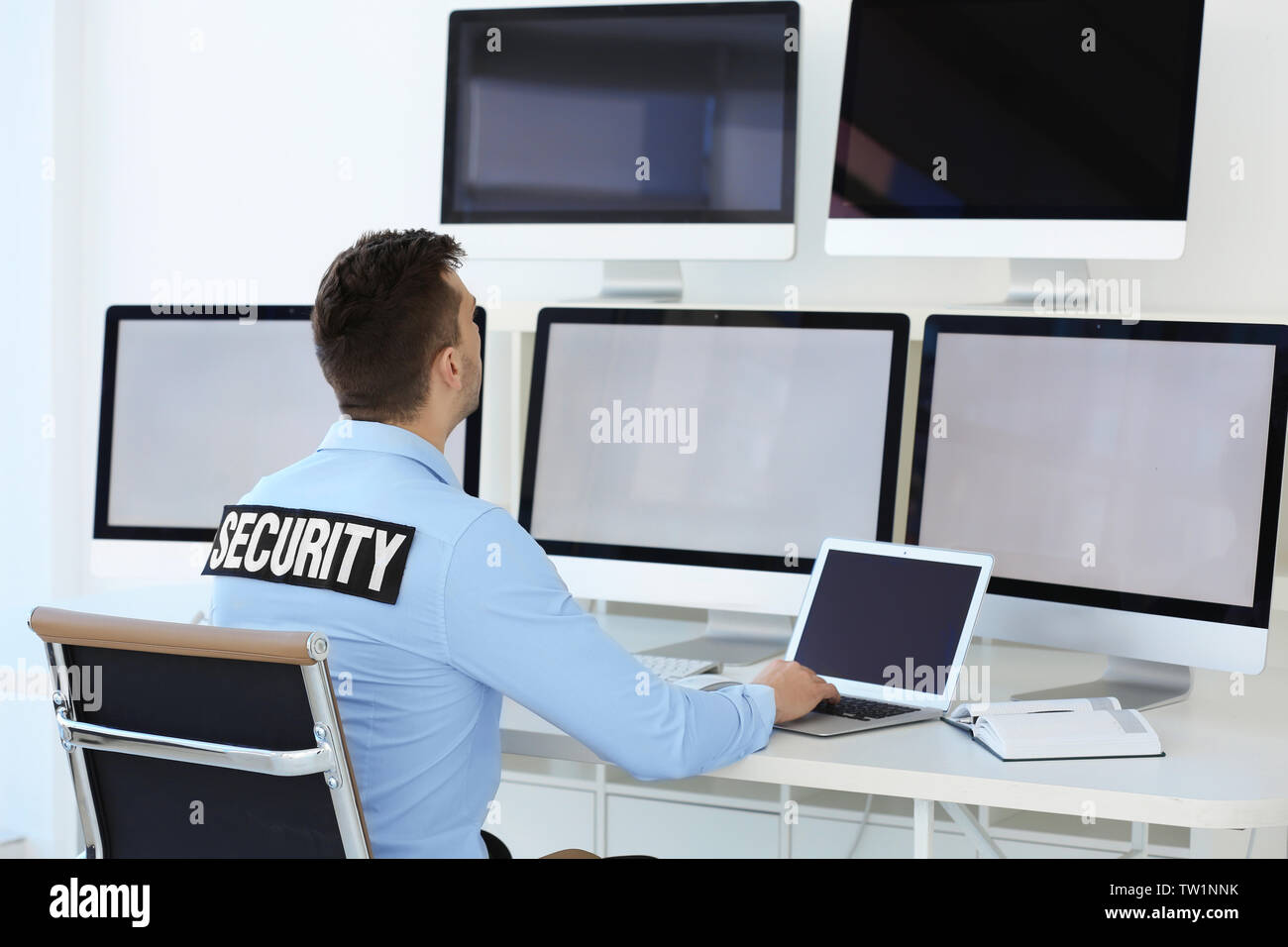 Handsome security guard in surveillance room Stock Photo - Alamy