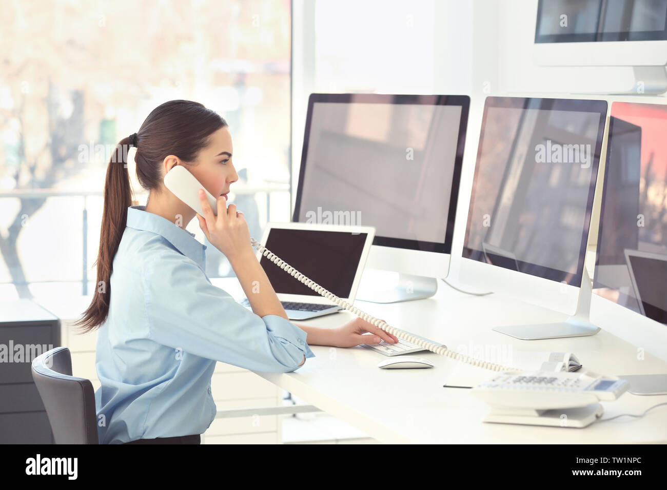 Beautiful security guard in surveillance room Stock Photo - Alamy