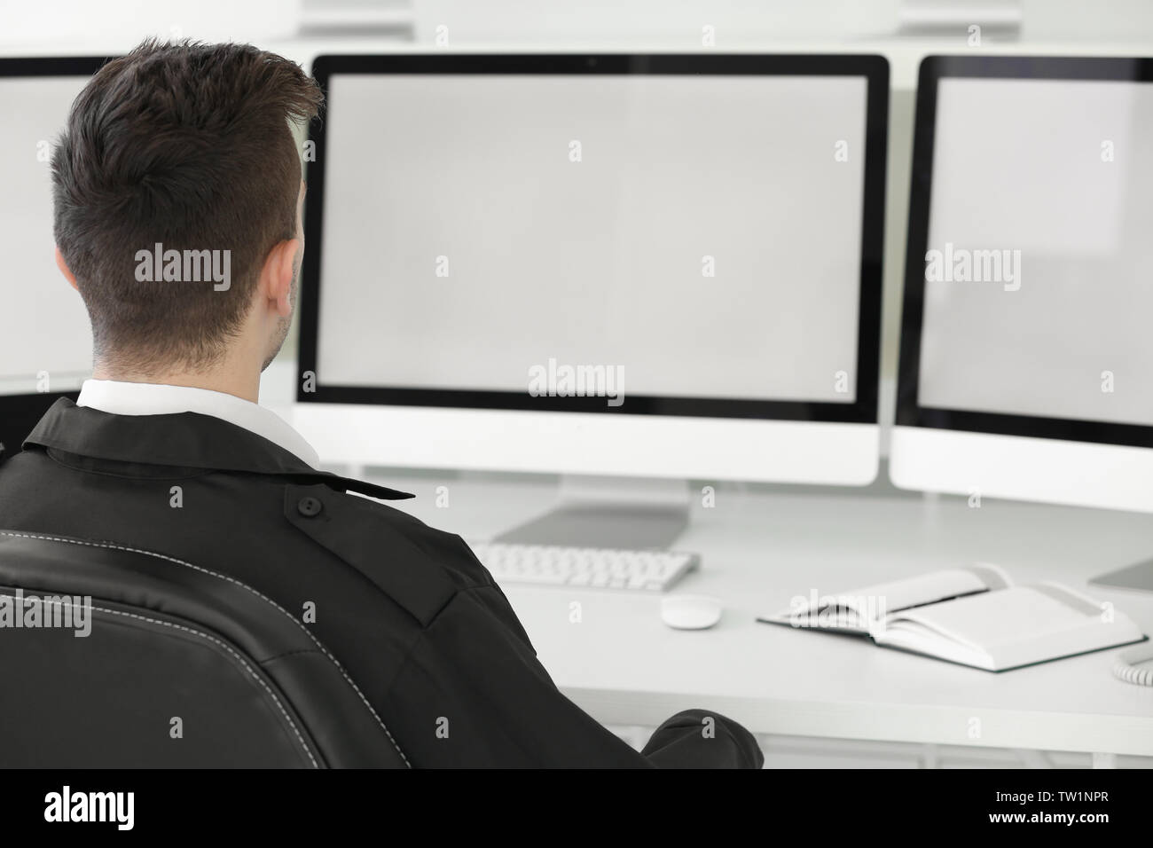Handsome security guard in surveillance room Stock Photo - Alamy