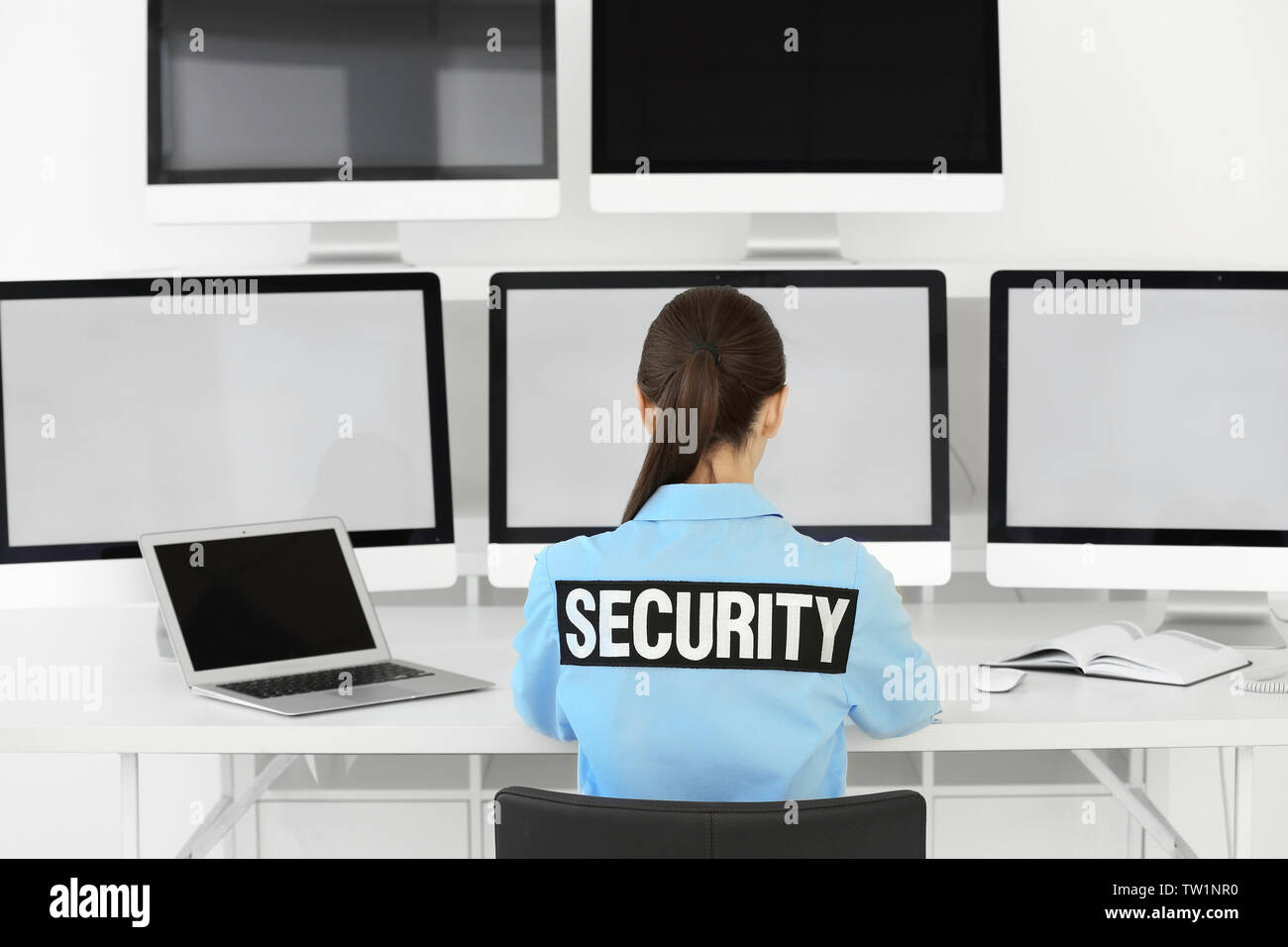 Beautiful security guard in surveillance room Stock Photo - Alamy