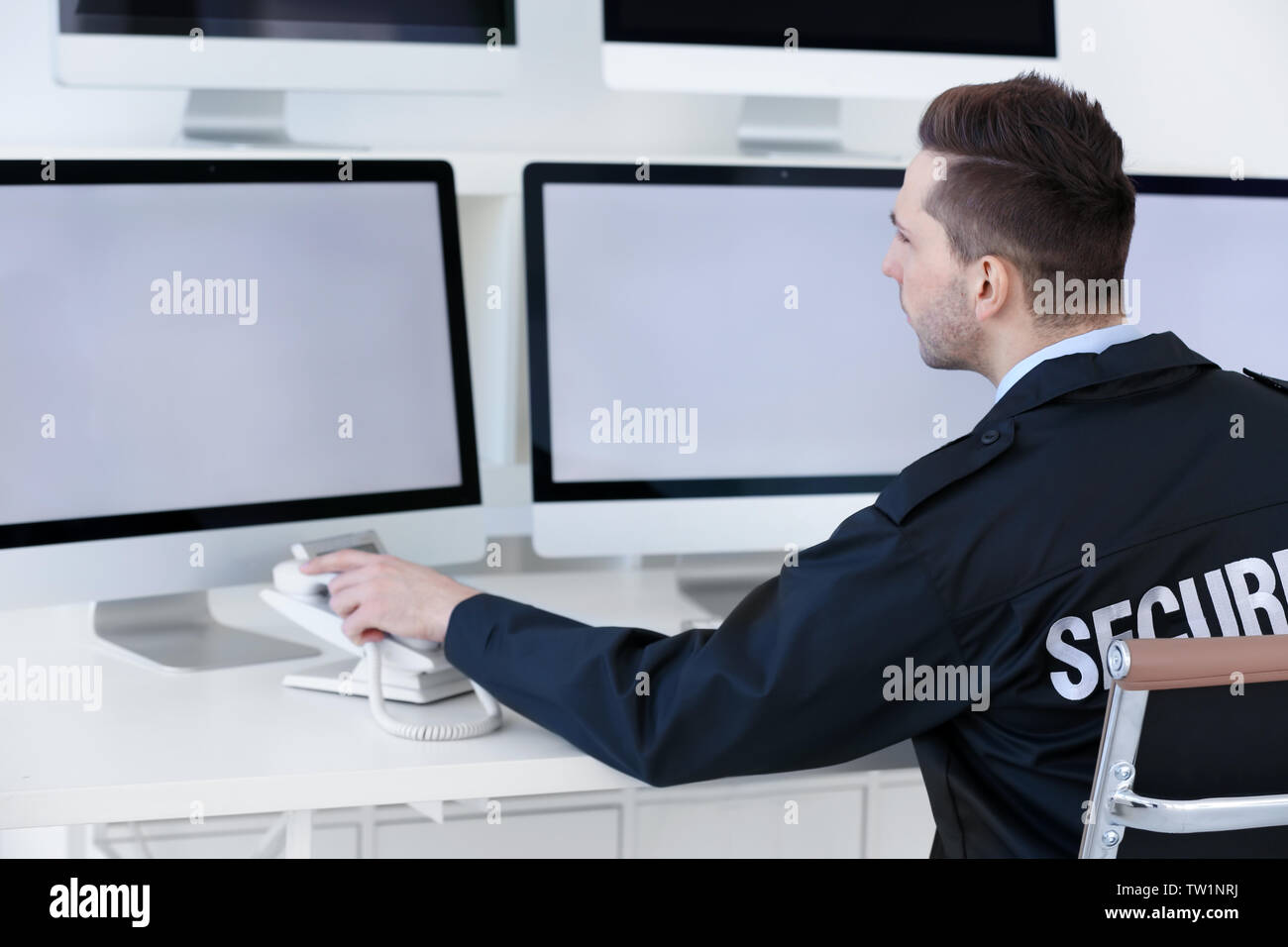 Handsome security guard in surveillance room Stock Photo - Alamy