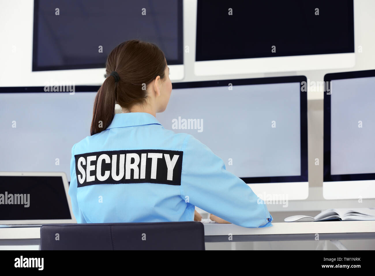 Beautiful security guard in surveillance room Stock Photo - Alamy