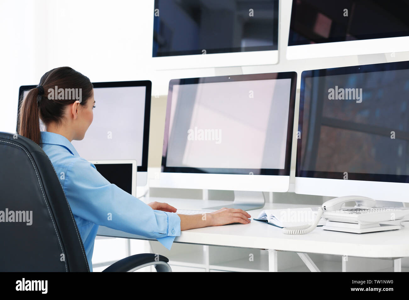 Beautiful security guard in surveillance room Stock Photo - Alamy