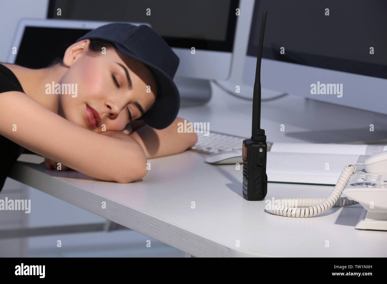 Beautiful security guard sleeping in surveillance room Stock Photo - Alamy