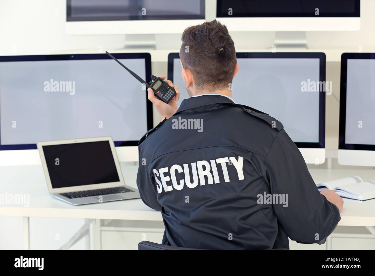 Handsome security guard in surveillance room Stock Photo - Alamy