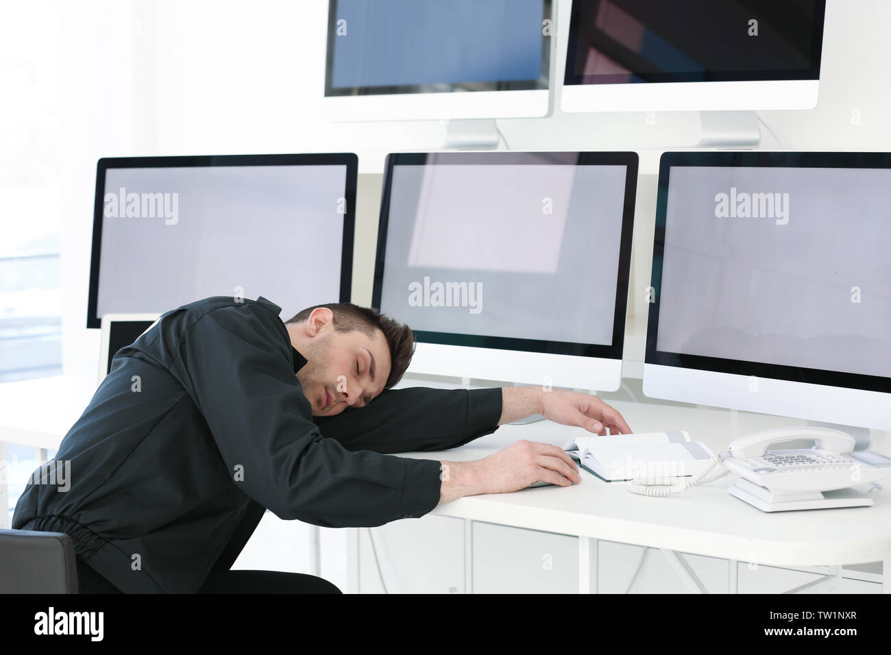 Security guard sleeping in chair hi-res stock photography and images ...