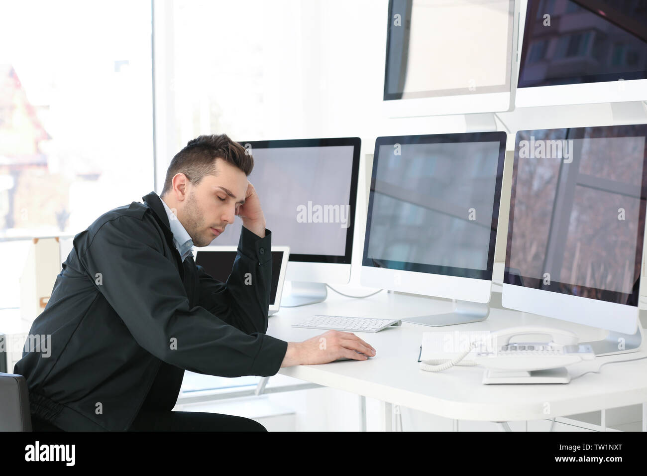 Handsome security guard sleeping in surveillance room Stock Photo - Alamy