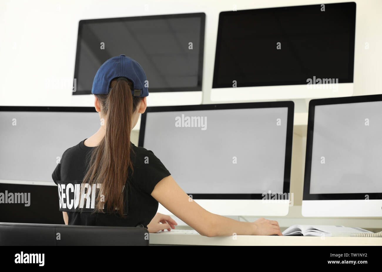 Beautiful security guard in surveillance room Stock Photo - Alamy