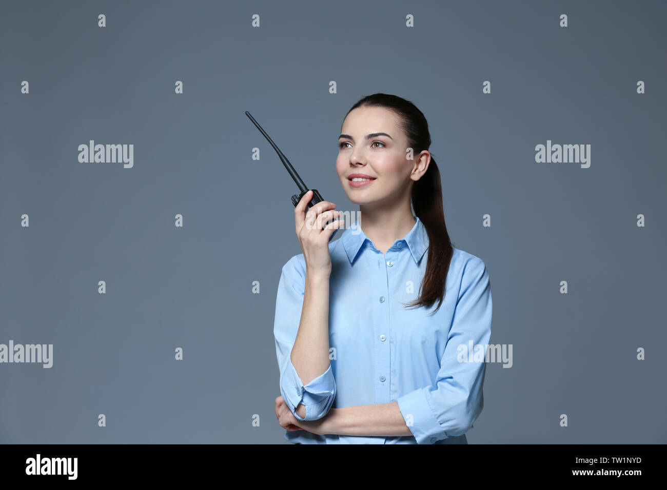 Beautiful security guard on grey background Stock Photo - Alamy