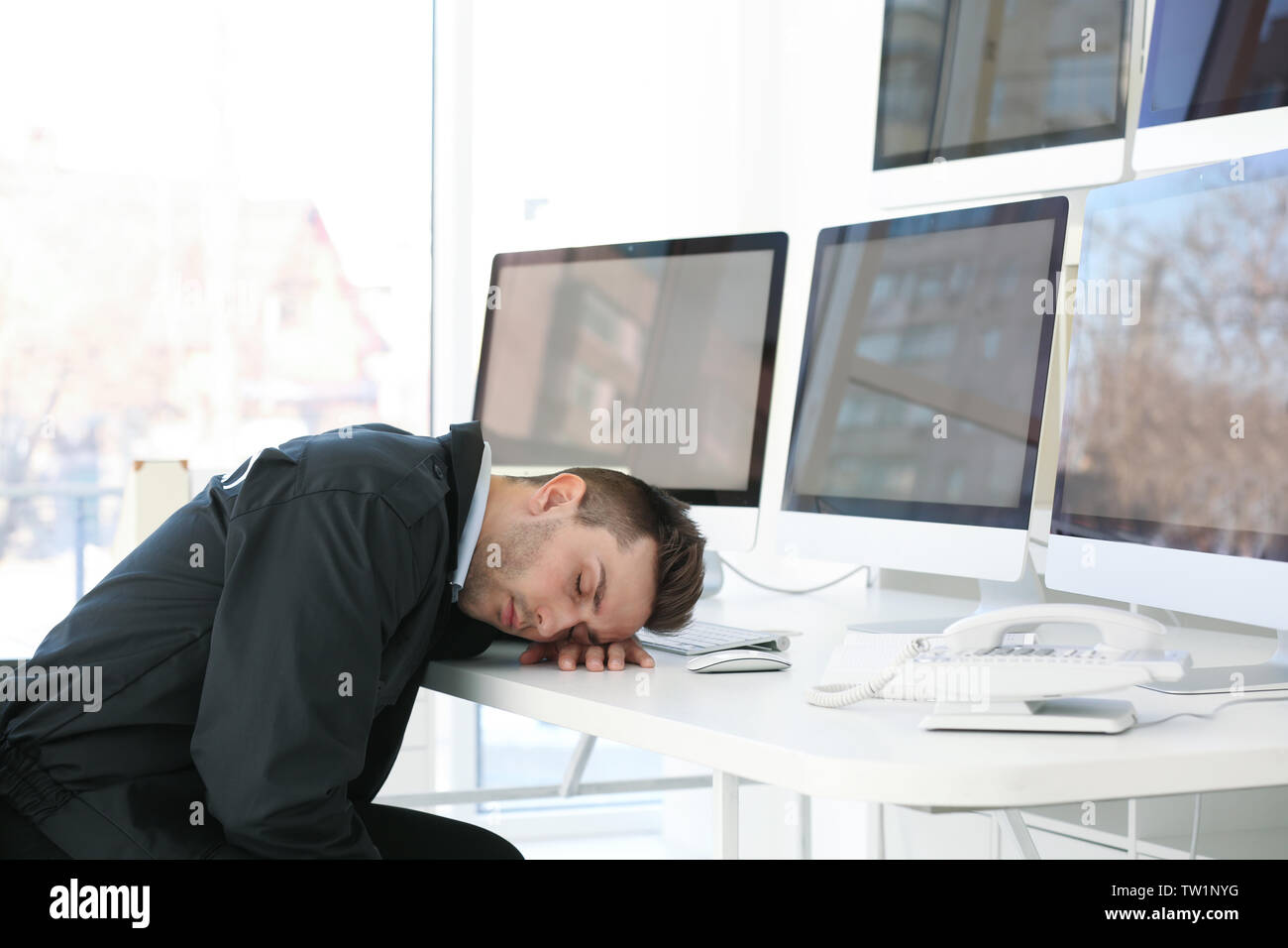 Handsome security guard sleeping in surveillance room Stock Photo - Alamy