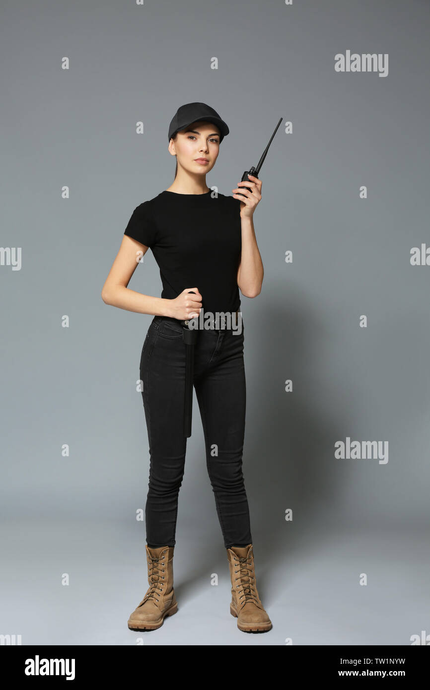 Beautiful young woman in security uniform on grey background Stock ...