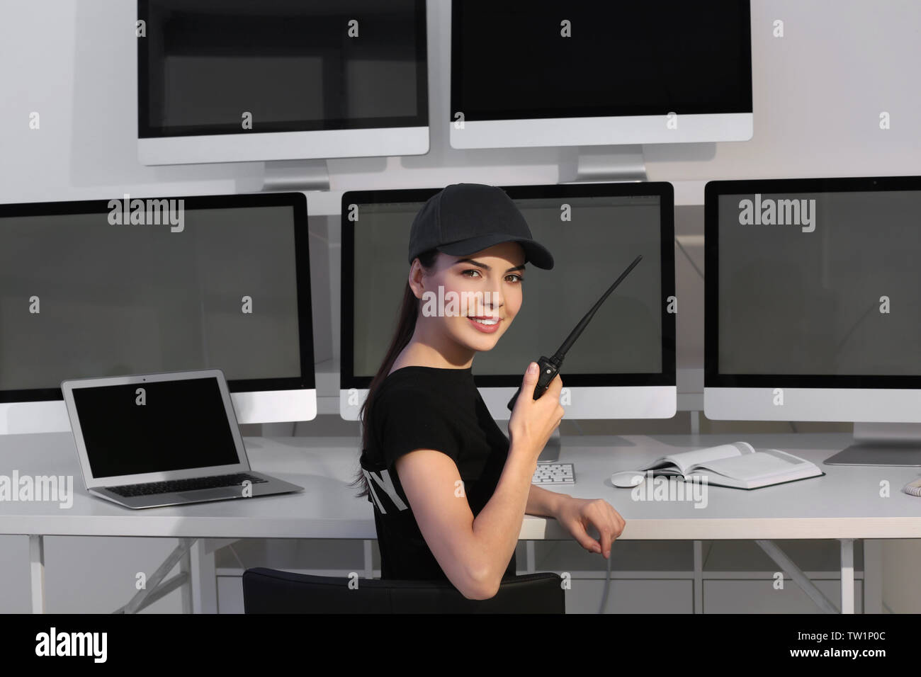 Beautiful security guard in surveillance room Stock Photo - Alamy