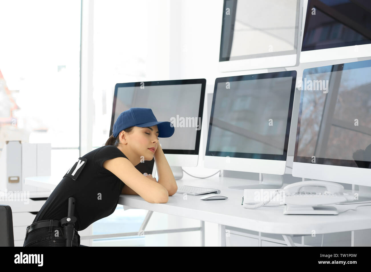 Beautiful security guard sleeping in surveillance room Stock Photo - Alamy