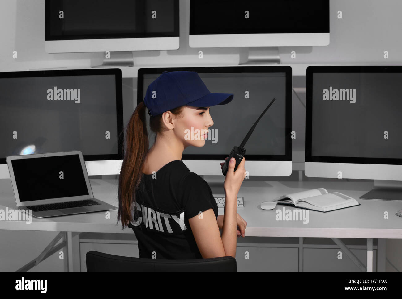 Beautiful security guard in surveillance room Stock Photo - Alamy