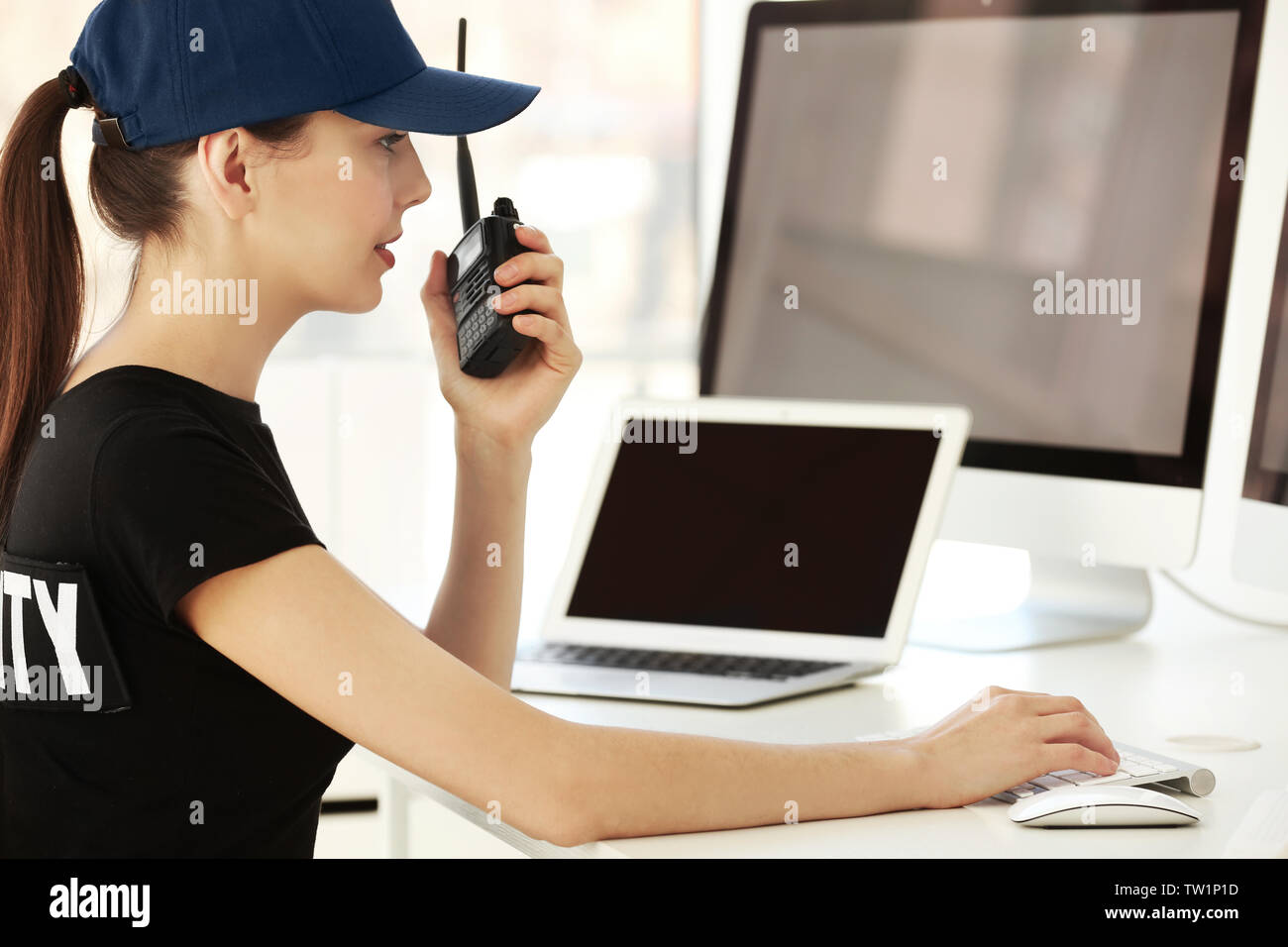 Beautiful security guard in surveillance room Stock Photo - Alamy